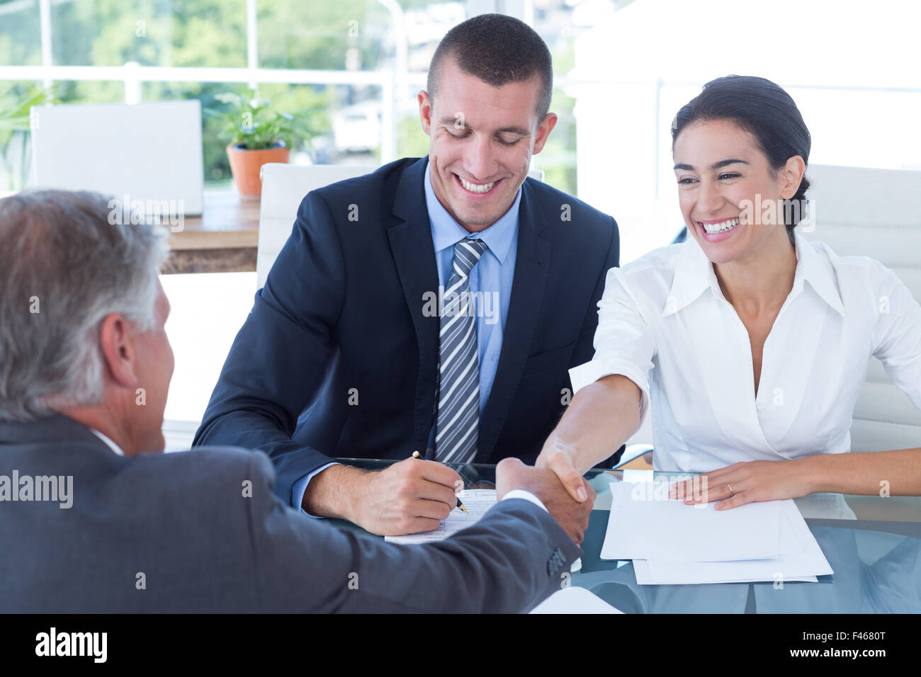Business partners shaking hands workplace hi-res stock photography and ...