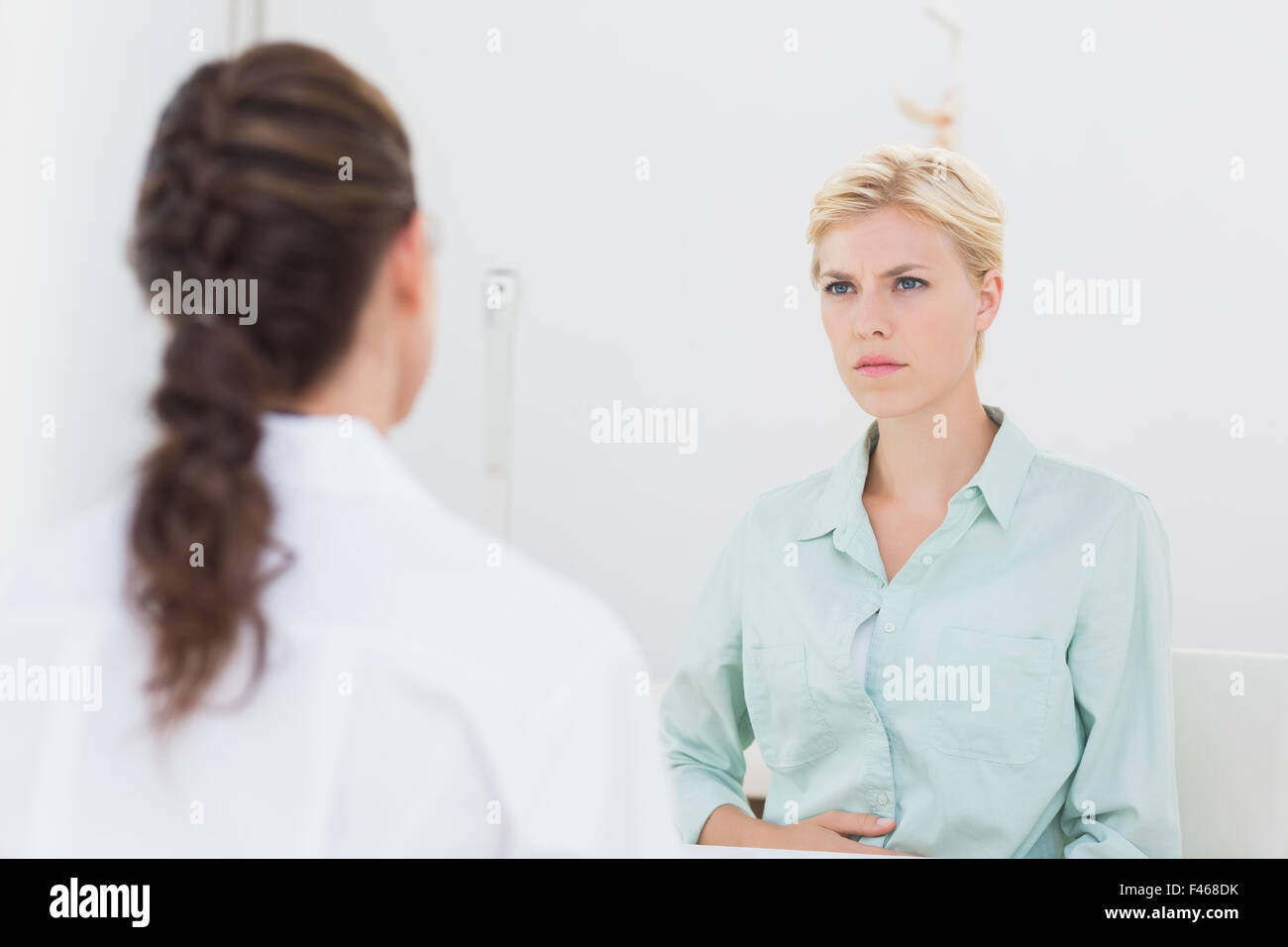 Unhappy patient speaking with doctor Stock Photo - Alamy