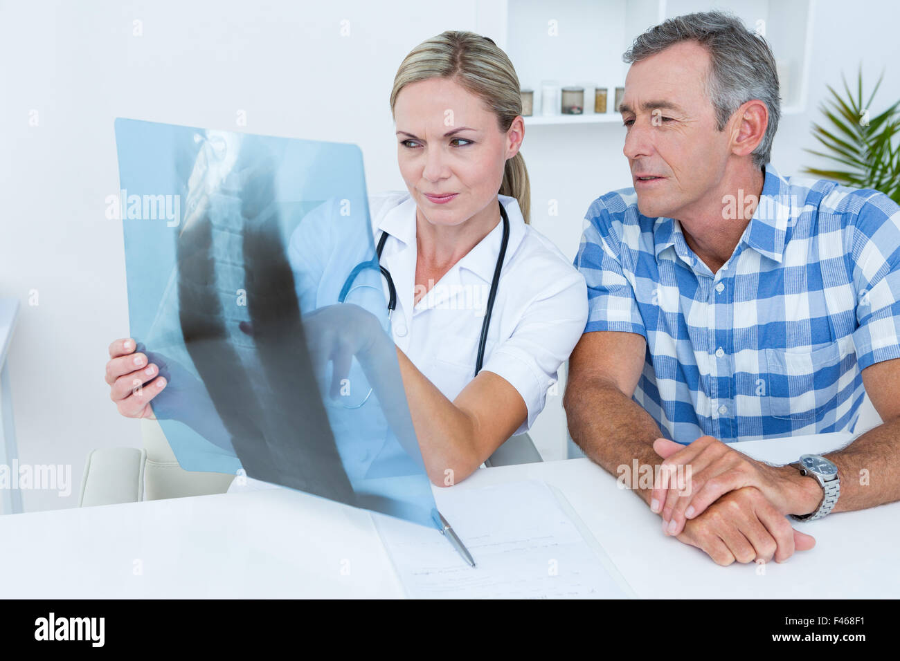Doctor showing X rays to her patient Stock Photo - Alamy