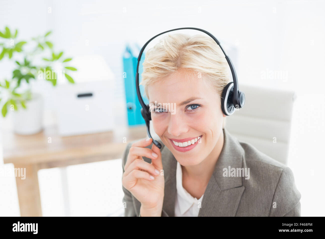 Businesswoman wearing a work headset Stock Photo - Alamy