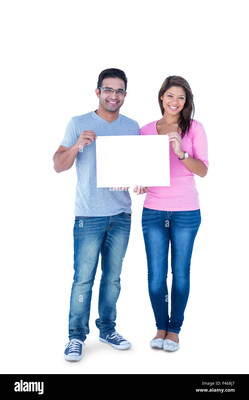 Smiling friends holding blank sign together Stock Photo - Alamy