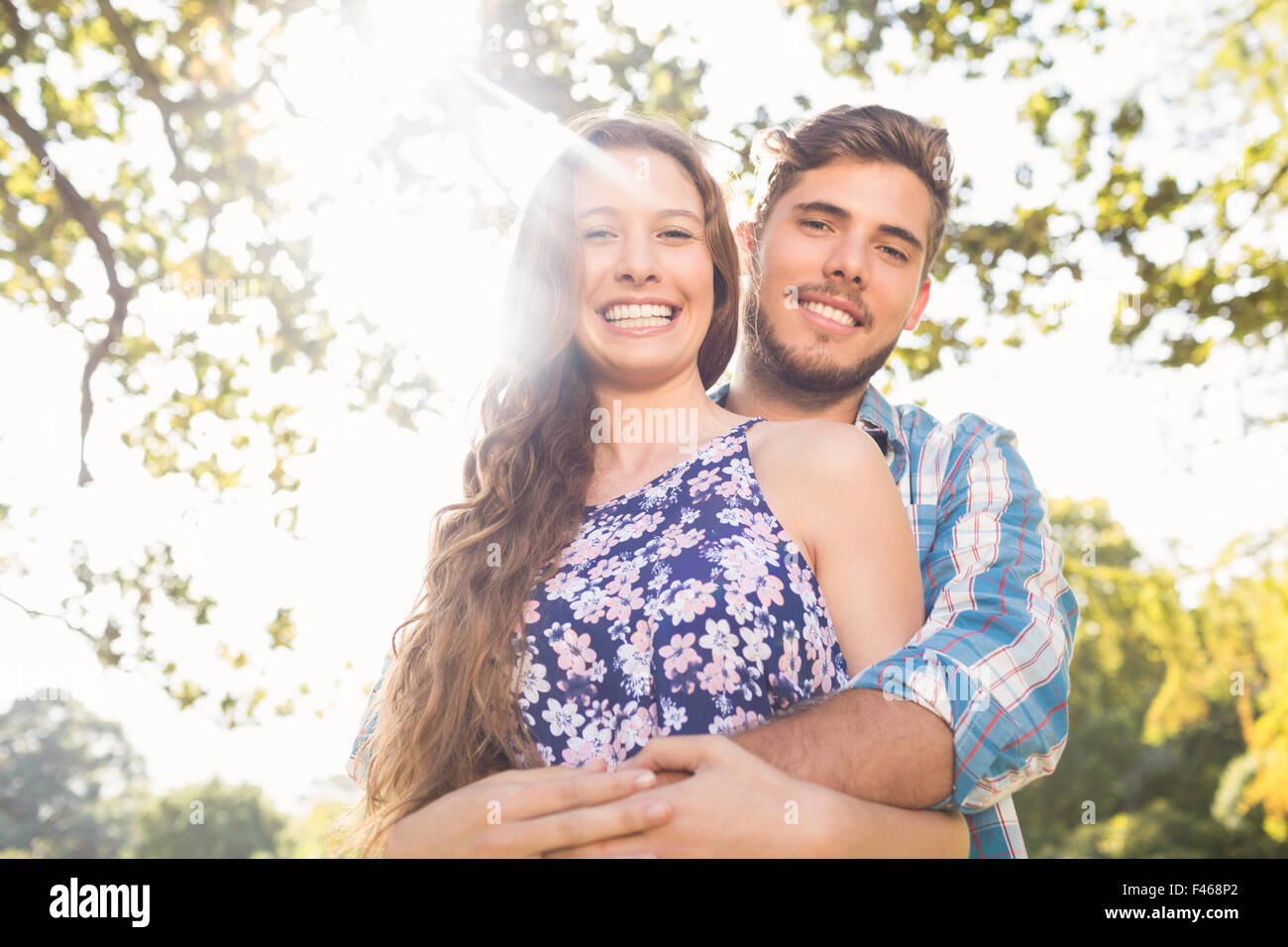 Cute couple hugging in the park Stock Photo - Alamy