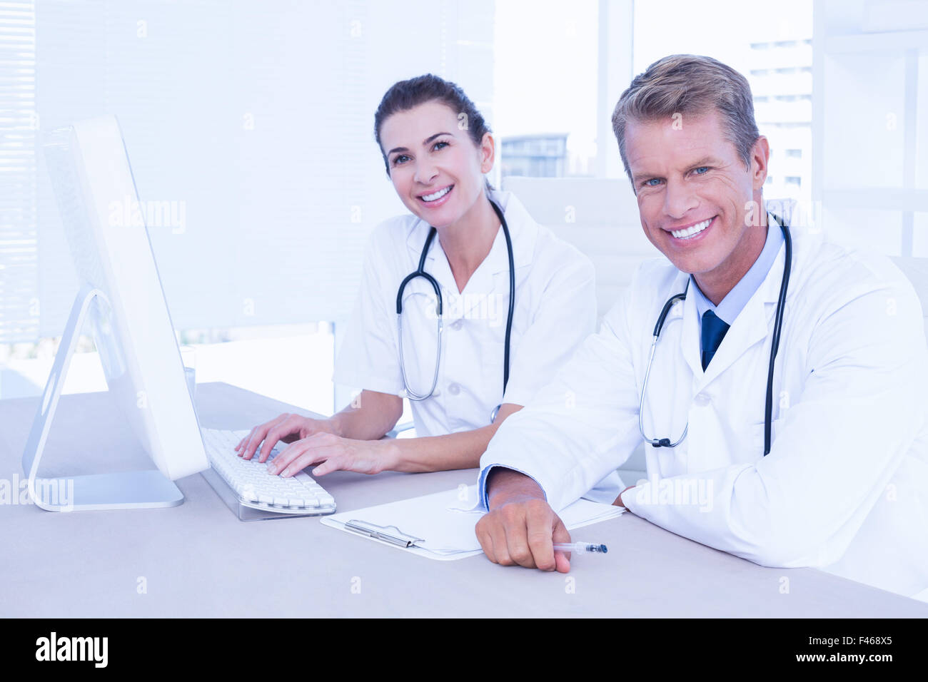 Serious doctors using computer Stock Photo - Alamy