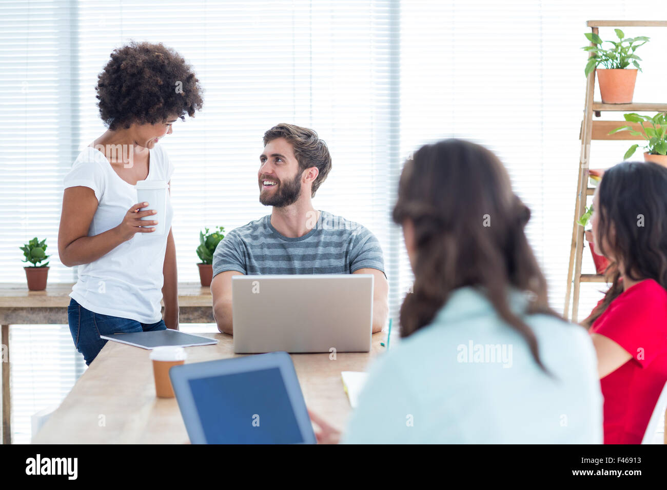 Happy business team working together Stock Photo - Alamy