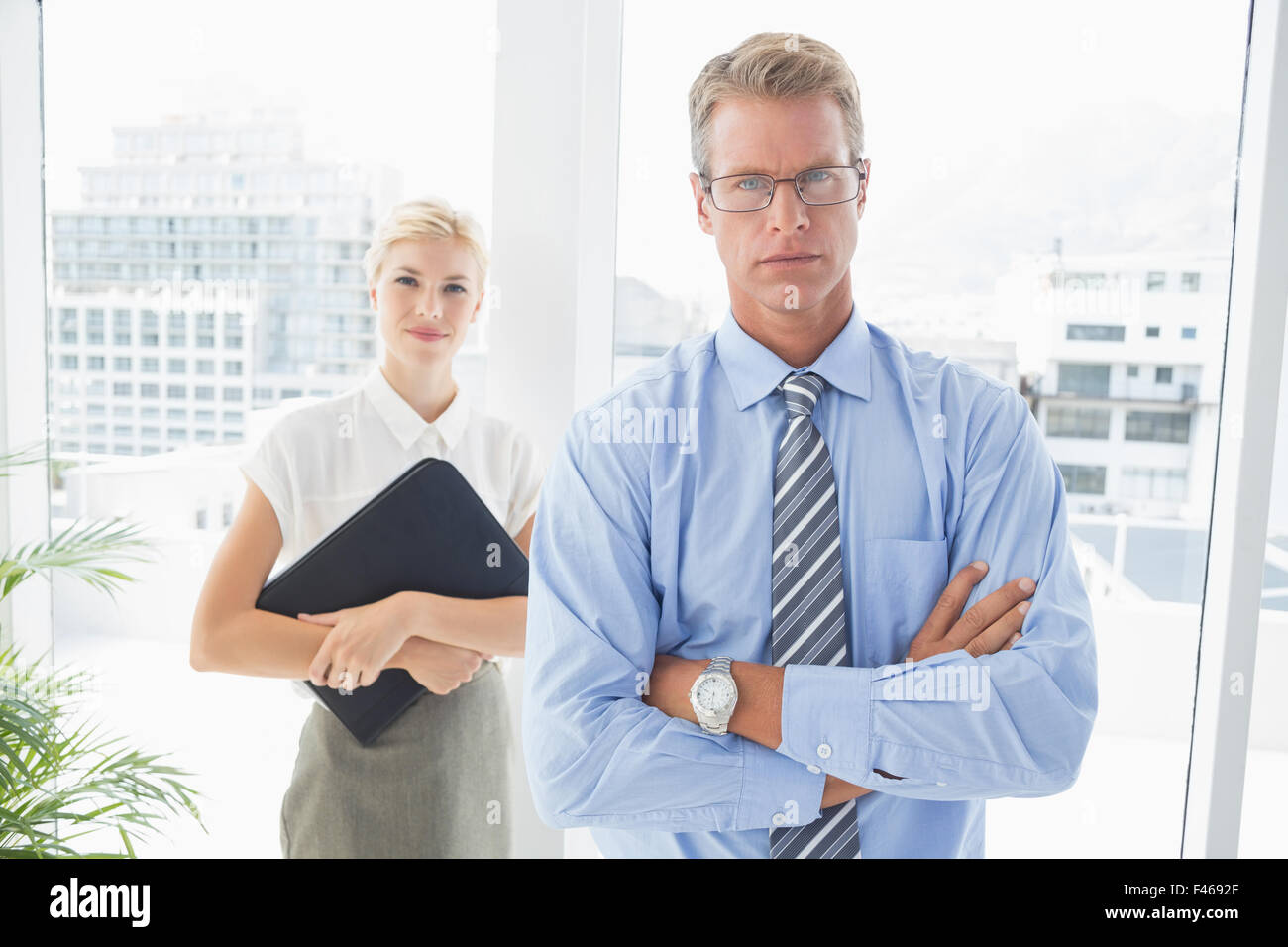 Business partners looking camera hi-res stock photography and images ...
