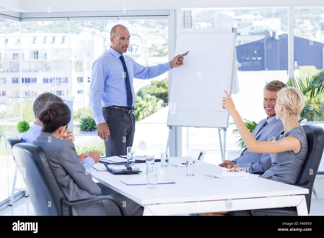 Businesswoman asking question during meeting Stock Photo - Alamy
