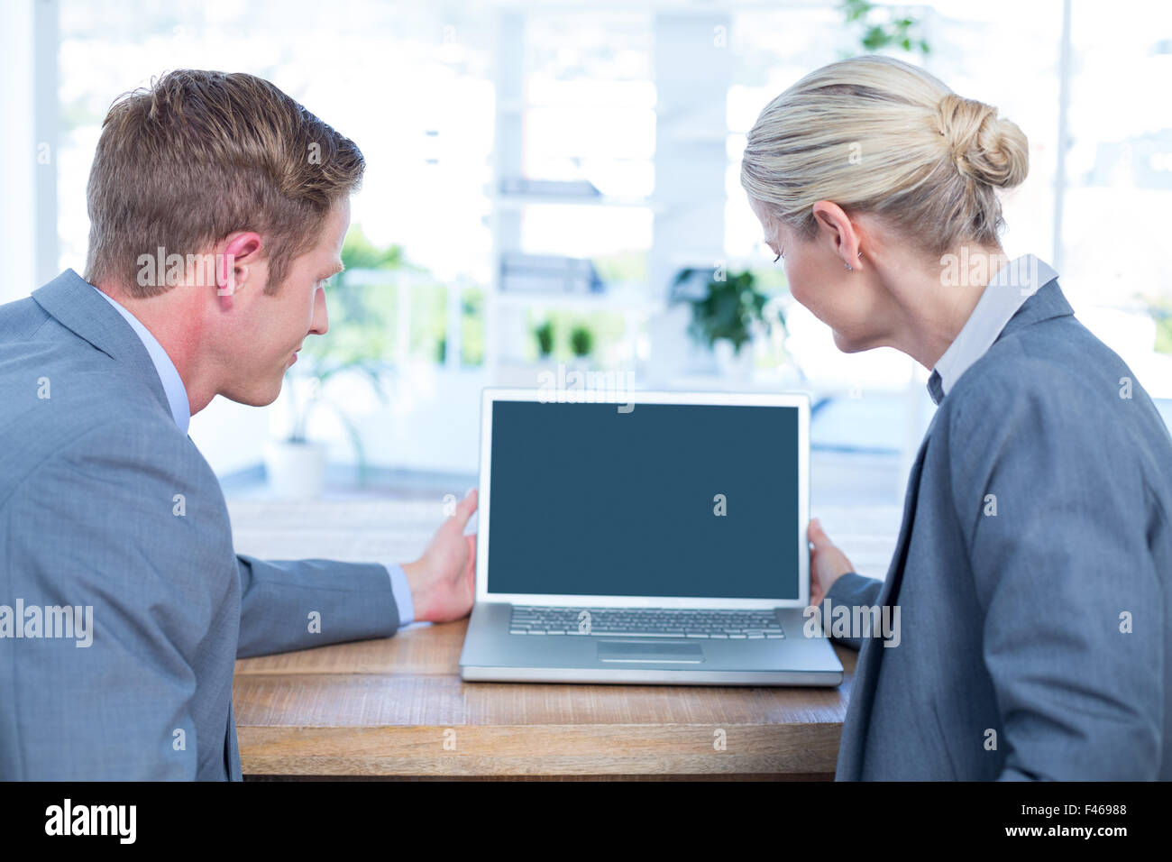 Business people watching laptop Stock Photo - Alamy