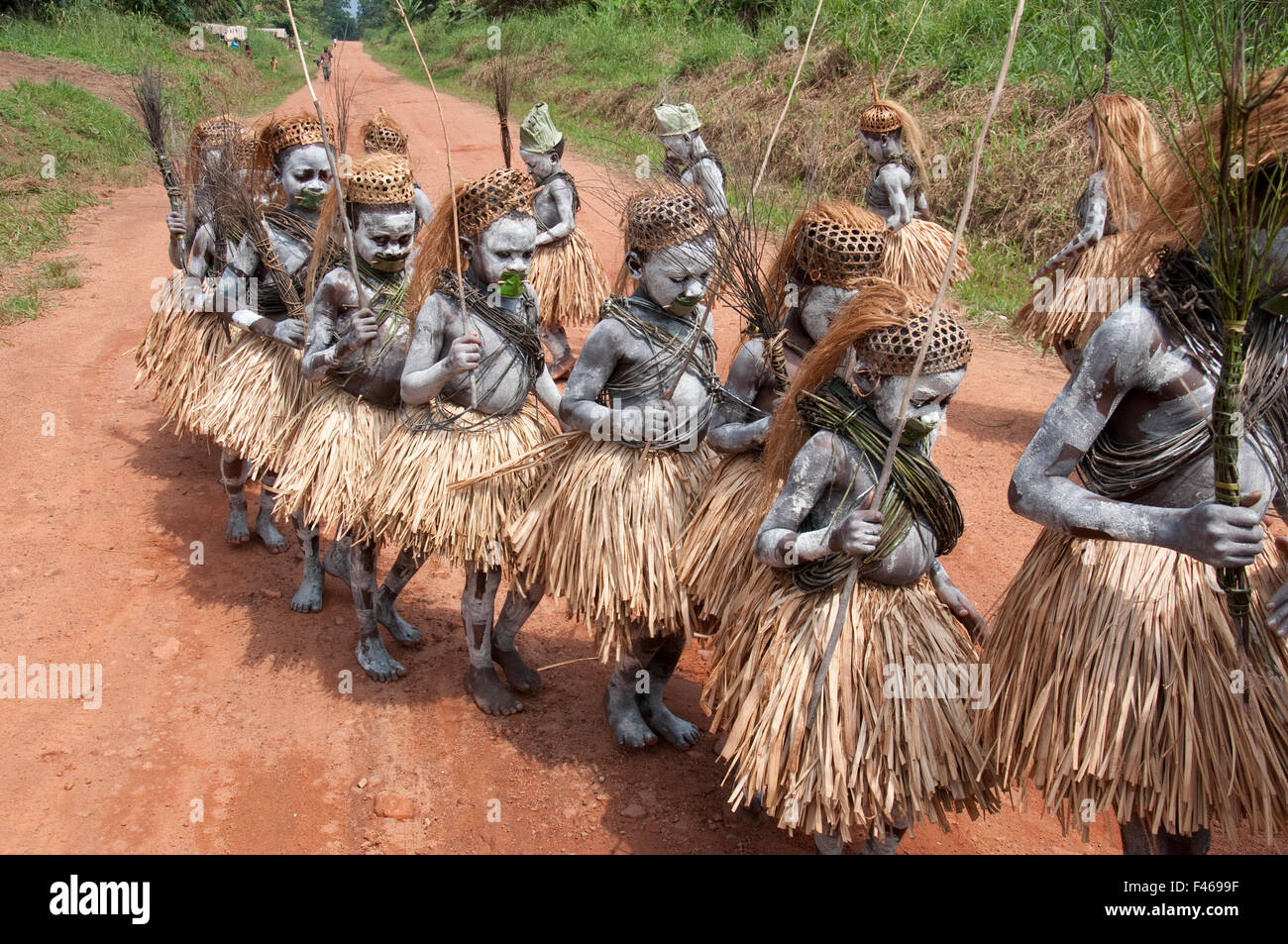 Mbuti Pygmy boys in traditional blue body paint and straw skirts, on ...