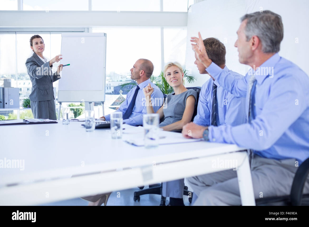 Businessman asking question during meeting Stock Photo - Alamy