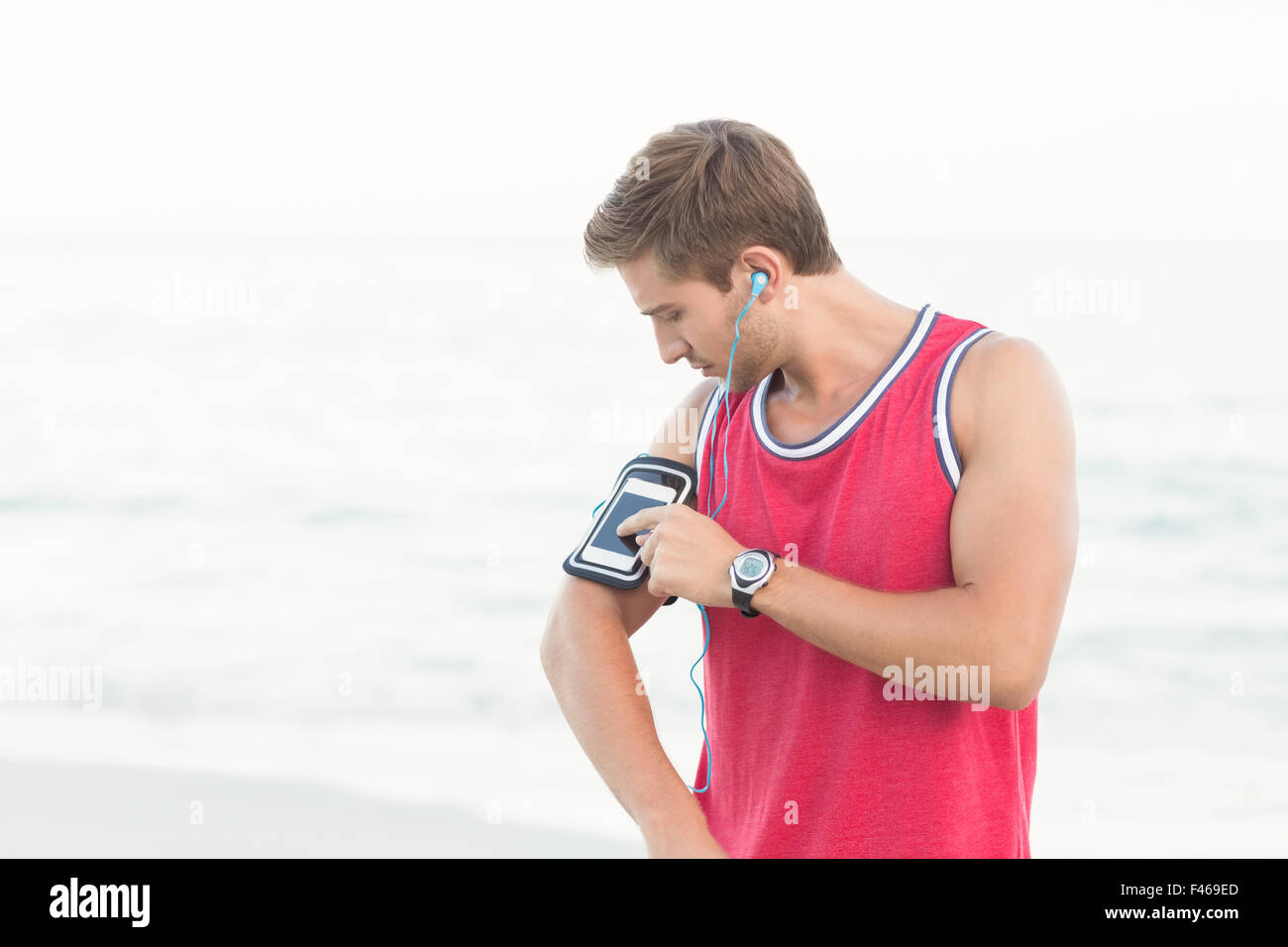 Handsome runner using his phone Stock Photo - Alamy