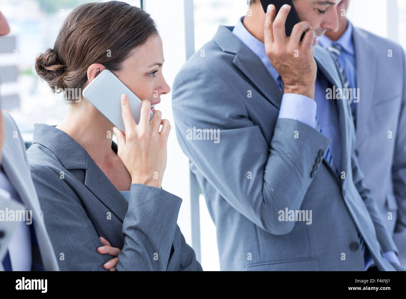 Employees using their mobile phone Stock Photo - Alamy