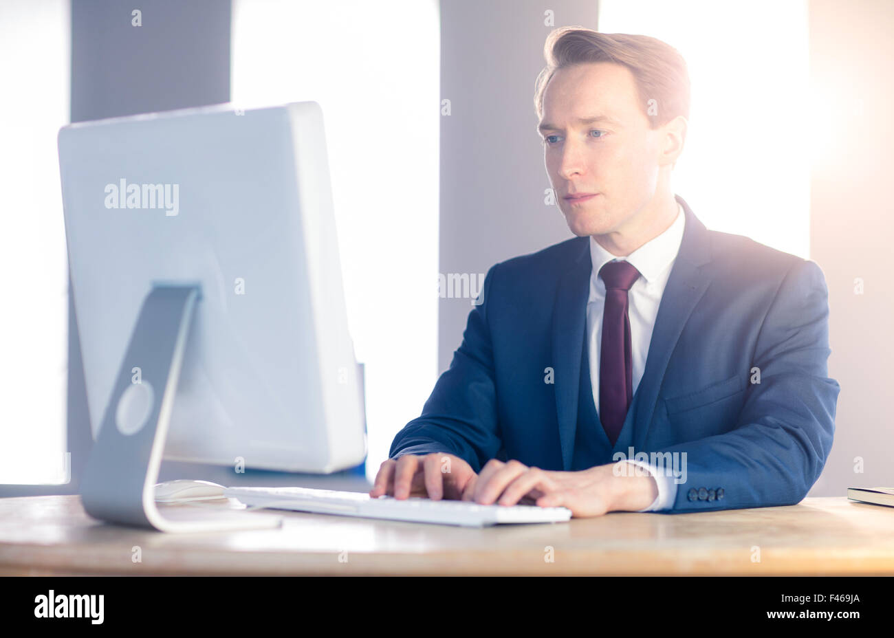 Serious businessman typing on computer Stock Photo - Alamy