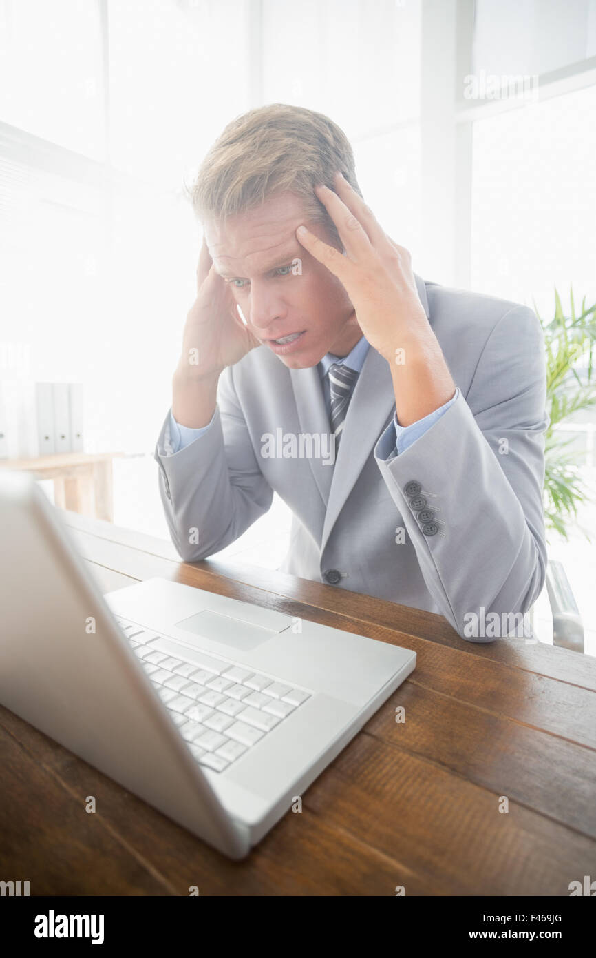 Depressed businessman at his desk Stock Photo - Alamy