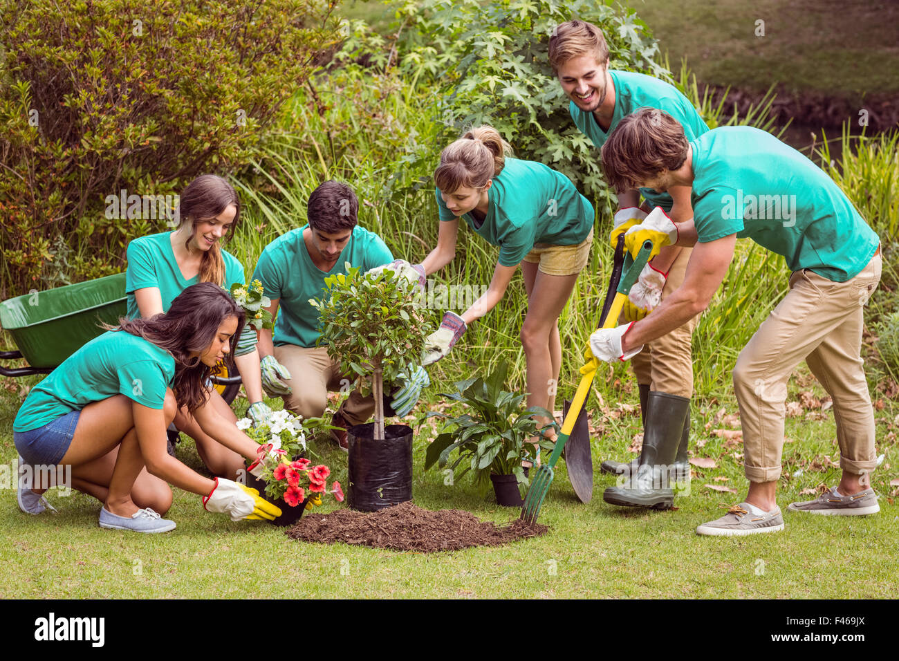 Happy friends gardening for the community Stock Photo - Alamy