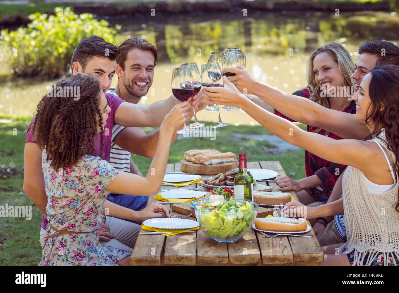 Happy friends in the park having lunch Stock Photo - Alamy