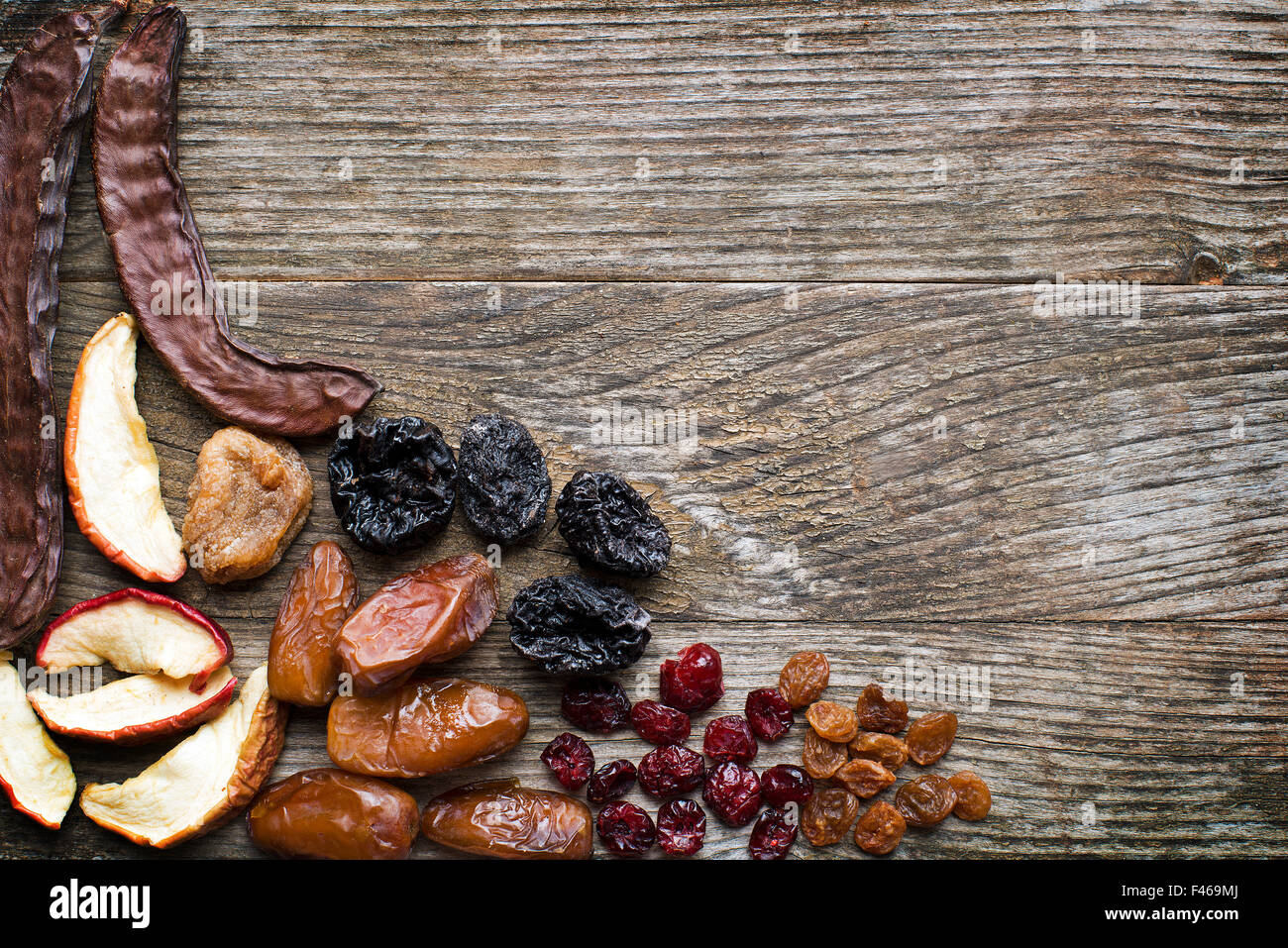 Organic Healthy Assorted Dried Fruit on a wooden background Stock Photo ...