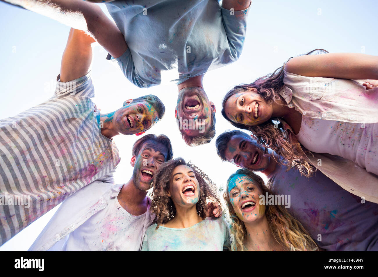 Happy friends covered in powder paint Stock Photo - Alamy