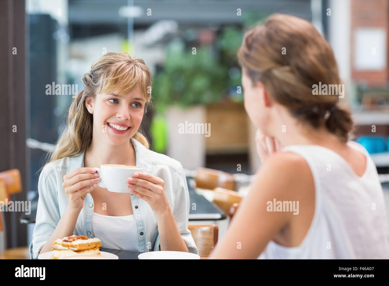 Blonde woman drinking coffee talking hi-res stock photography and ...