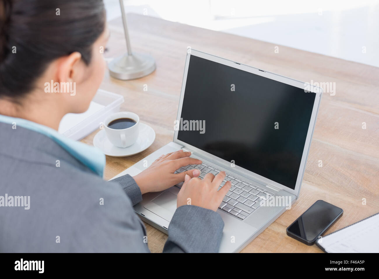 Businesswoman using her computer Stock Photo - Alamy