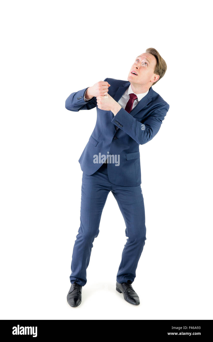 An anxious businessman pulling something Stock Photo - Alamy