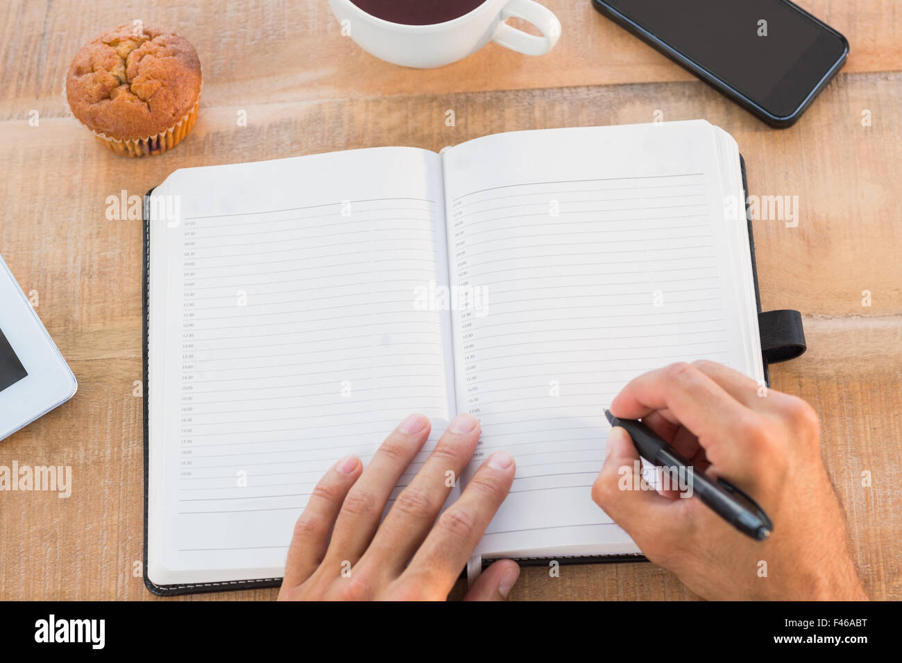 Man writing notes on diary Stock Photo - Alamy