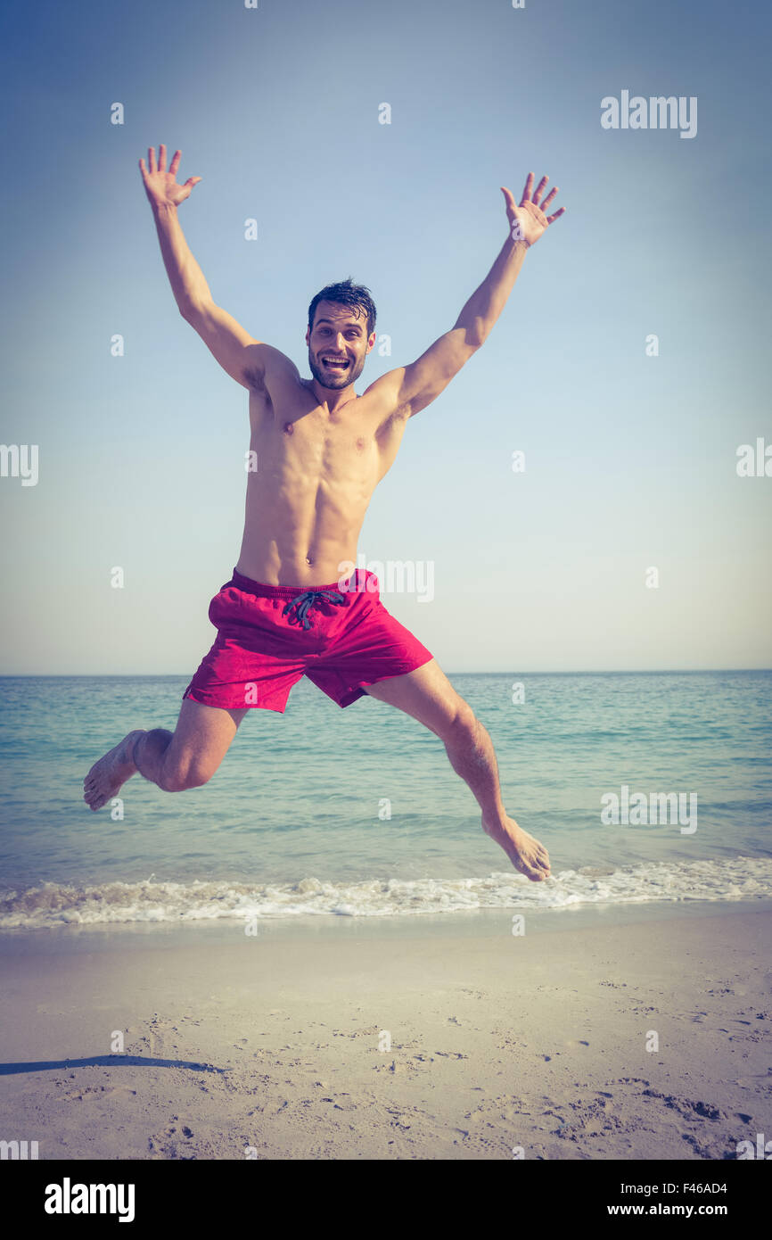 Man jumping on the beach hi-res stock photography and images - Alamy