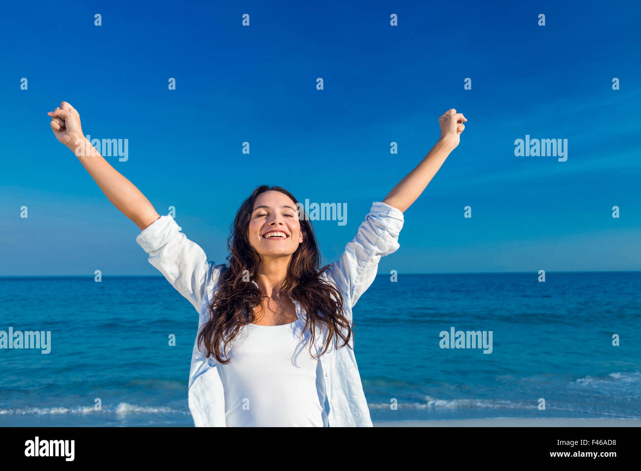 Happy woman smiling at the beach Stock Photo - Alamy