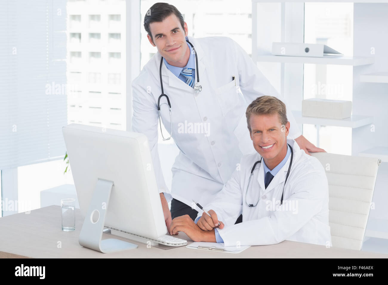 Smiling doctors looking at camera Stock Photo - Alamy