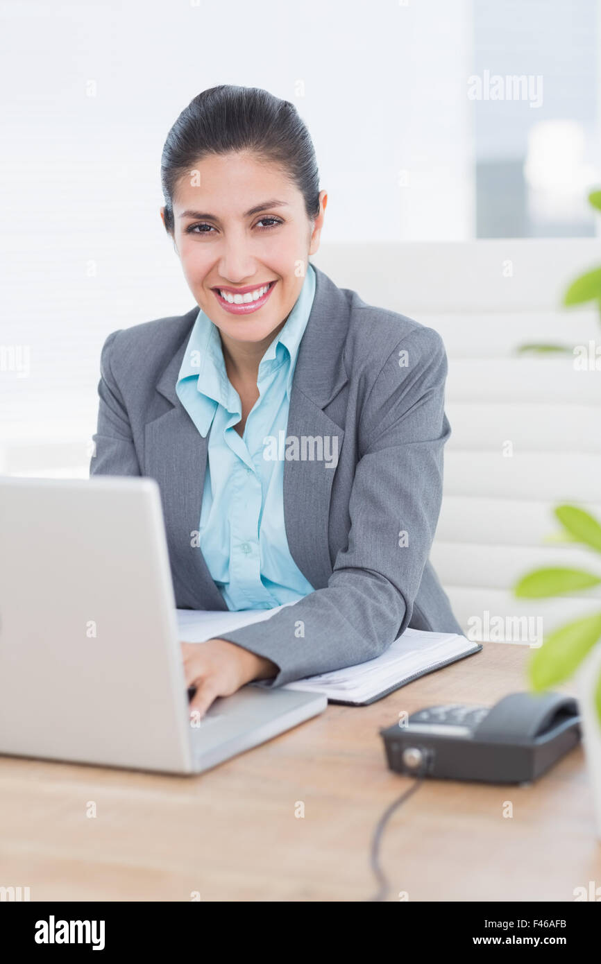 Smiling businesswoman using her computer Stock Photo - Alamy