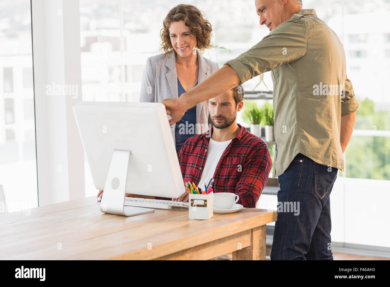 Creative business people working together on computer Stock Photo - Alamy