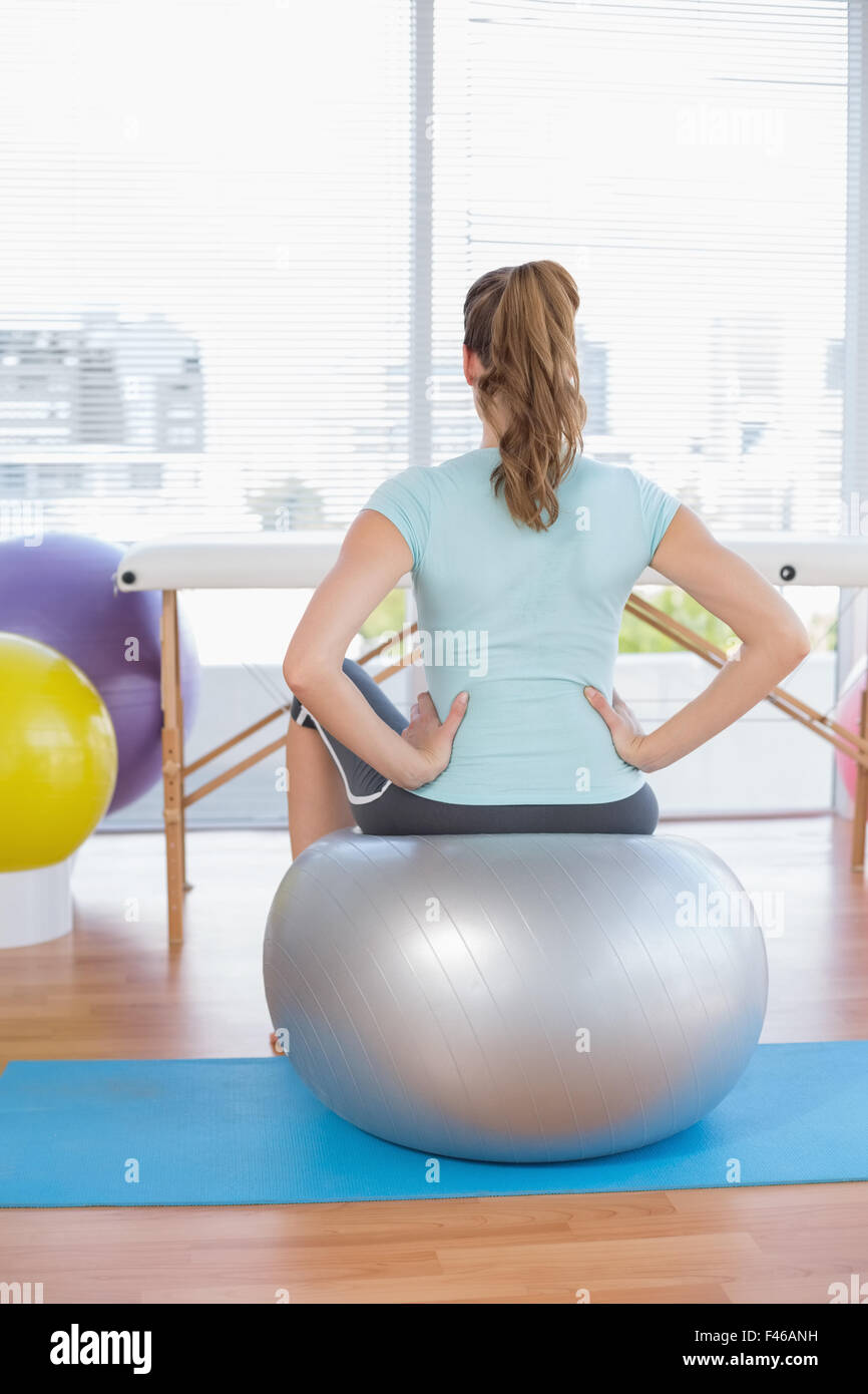 Woman sitting on exercise ball Stock Photo - Alamy