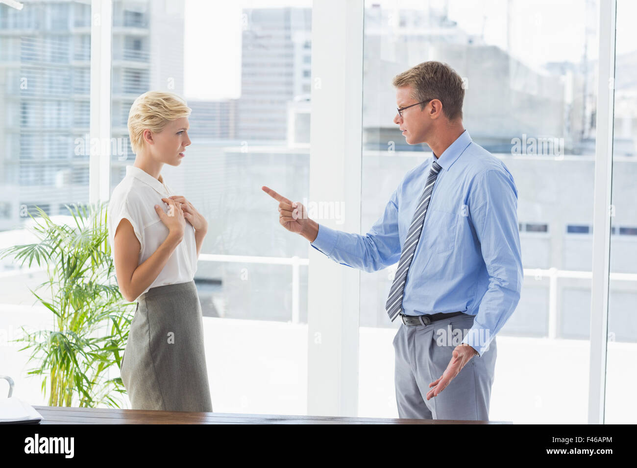 Businessman giving out to his colleague Stock Photo - Alamy