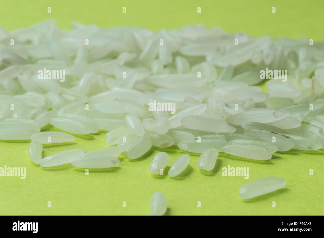Rice macro with green background Stock Photo - Alamy