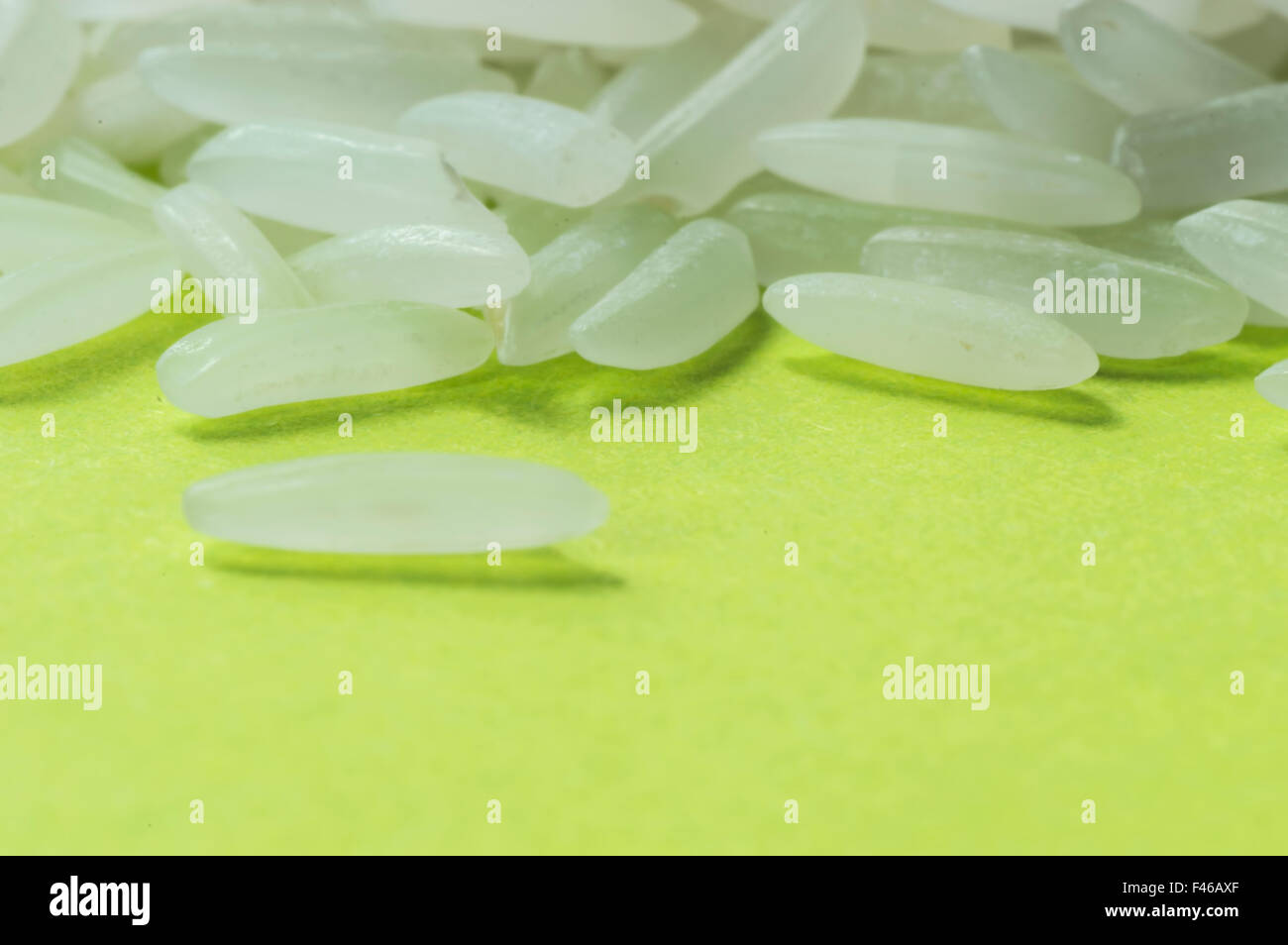 Rice macro with green background Stock Photo - Alamy