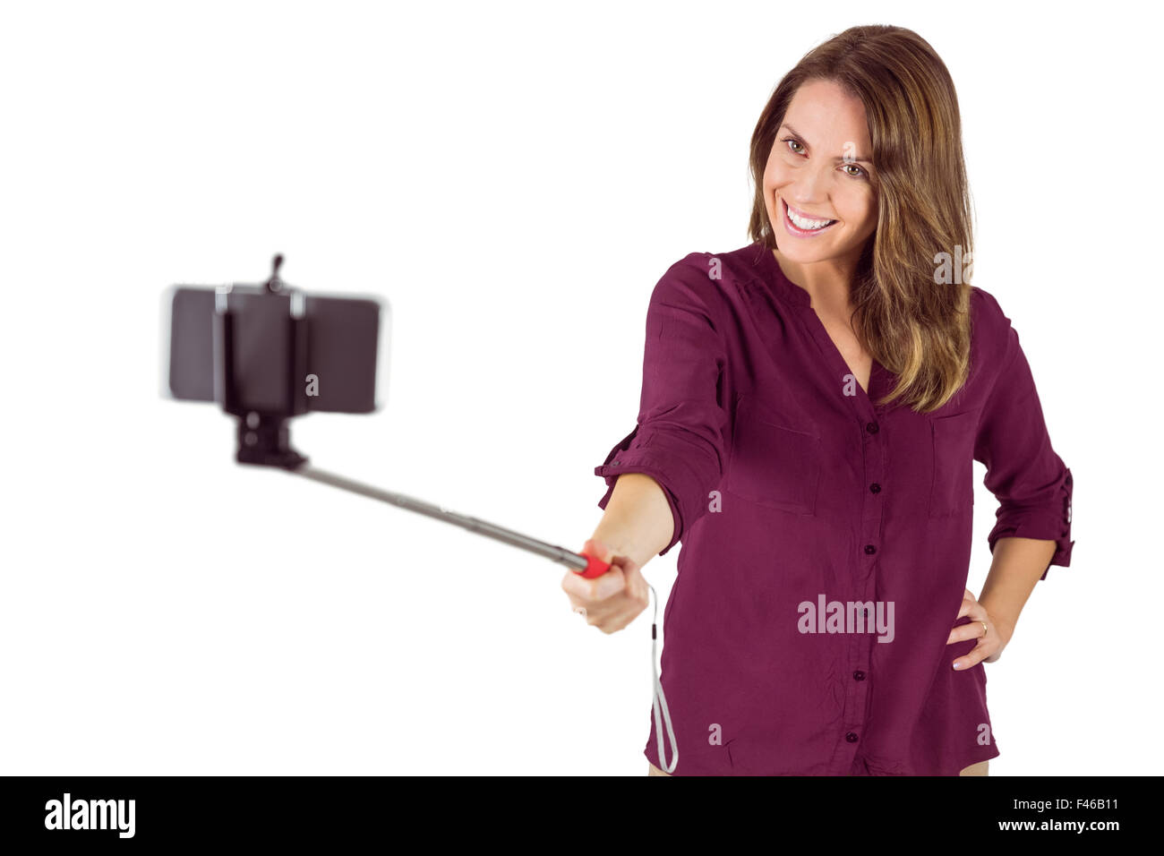 Pretty woman using a selfie stick Stock Photo - Alamy