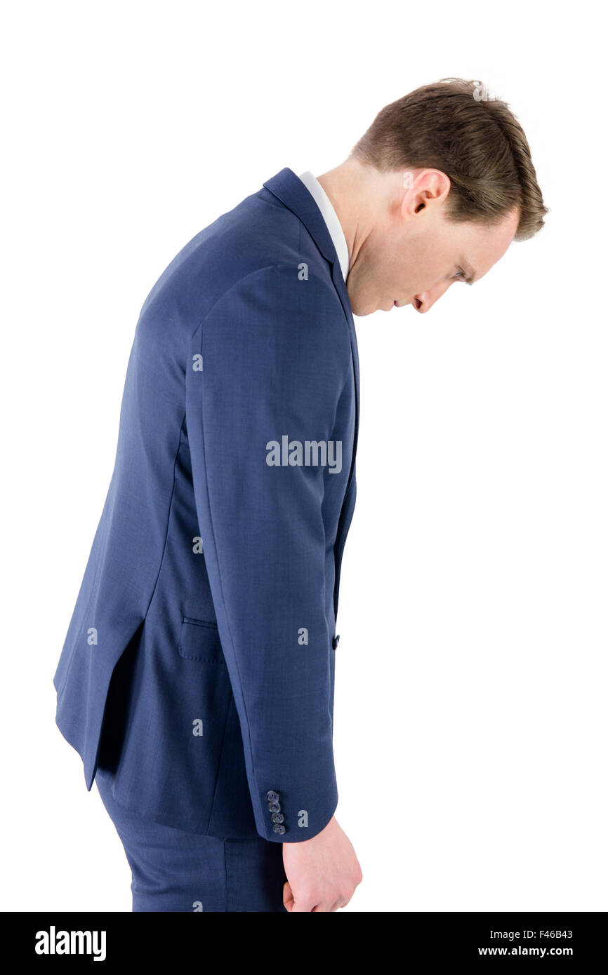 Defeated businessman looking down Stock Photo - Alamy