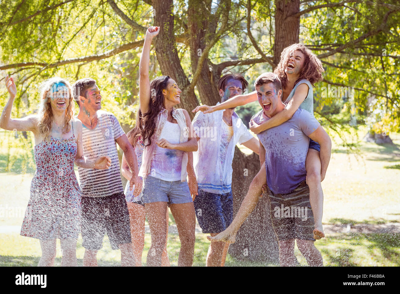 Happy friends jumping in the water shoot Stock Photo - Alamy
