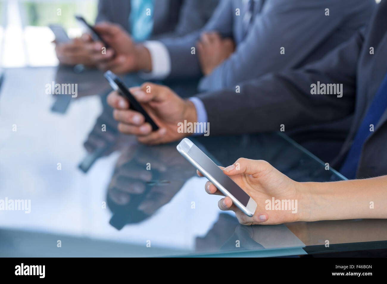 Employees using their mobile phone Stock Photo - Alamy