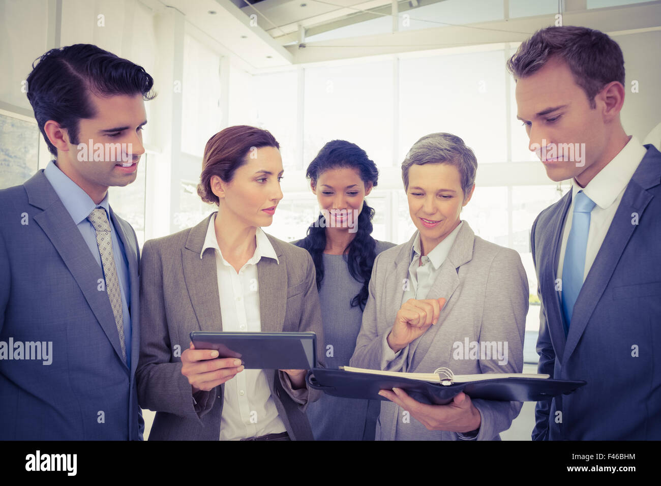Business people with tablet and notebook Stock Photo - Alamy