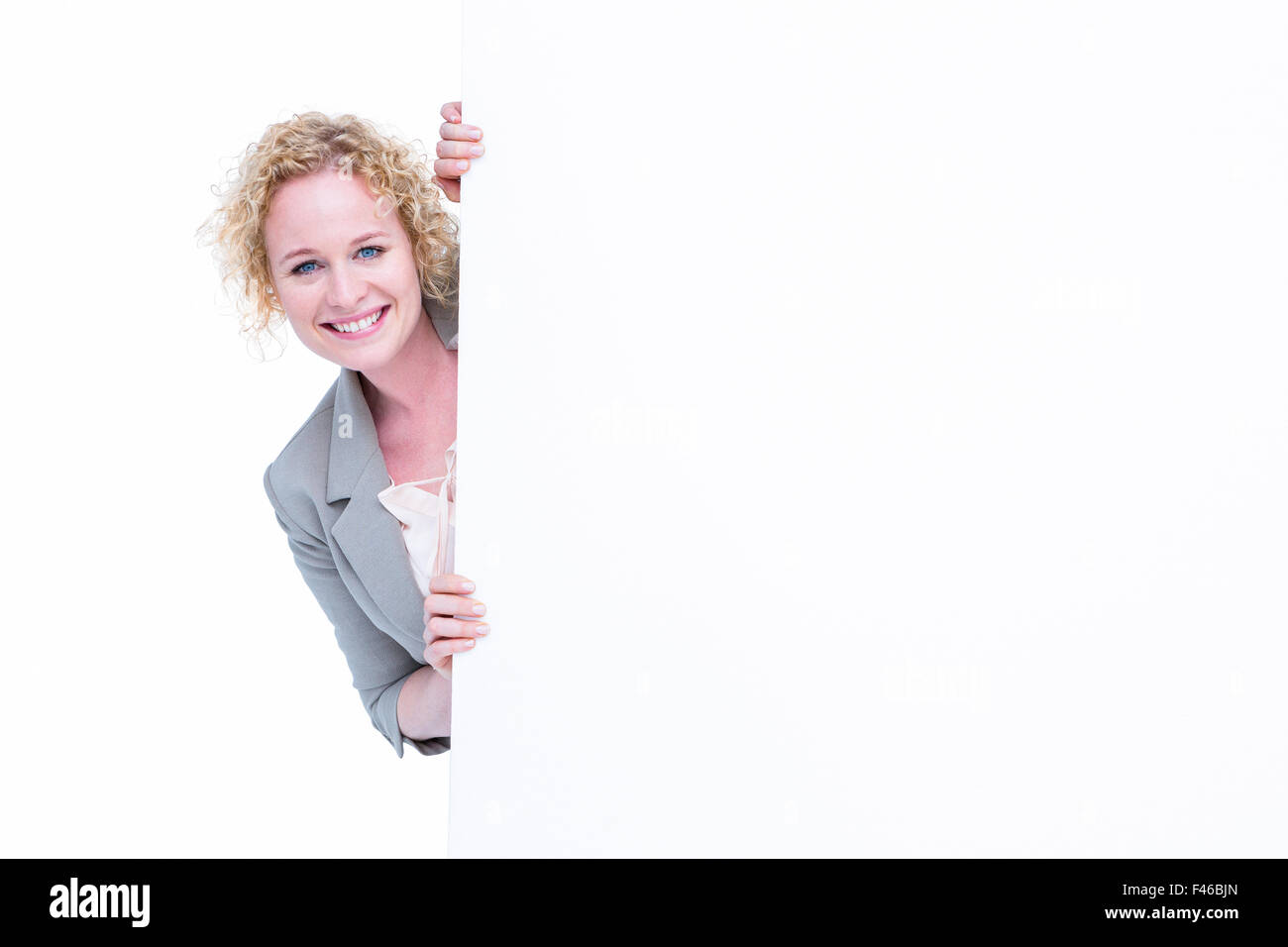 Woman looking around blank sign Stock Photo - Alamy