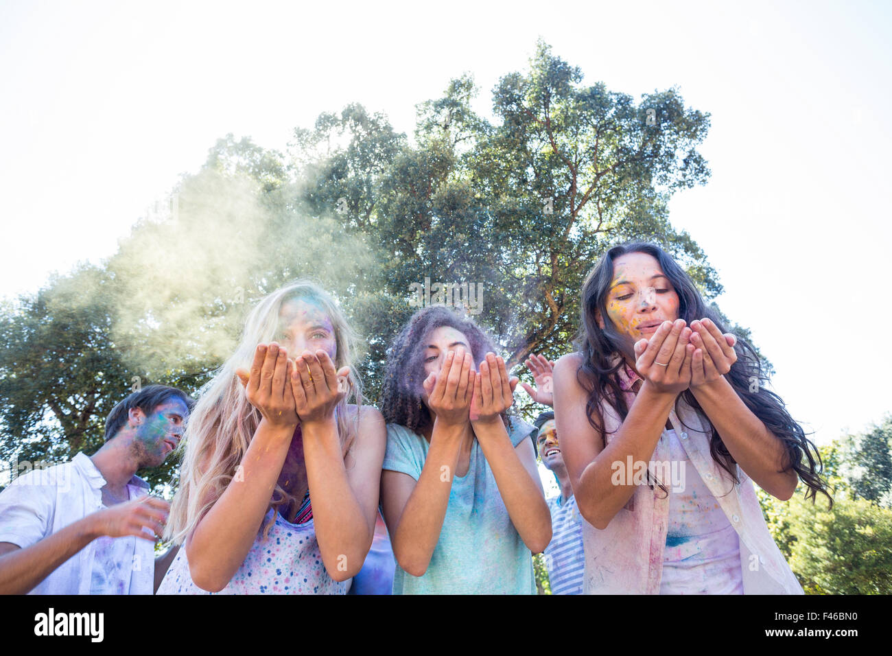 Happy friends playing with powder paint Stock Photo - Alamy