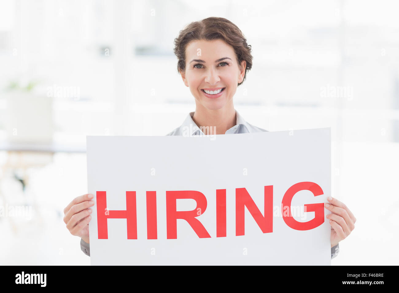 Businesswoman holding sign in front of her Stock Photo - Alamy Businesswoman holding sign in front of her Stock Photo - Alamy