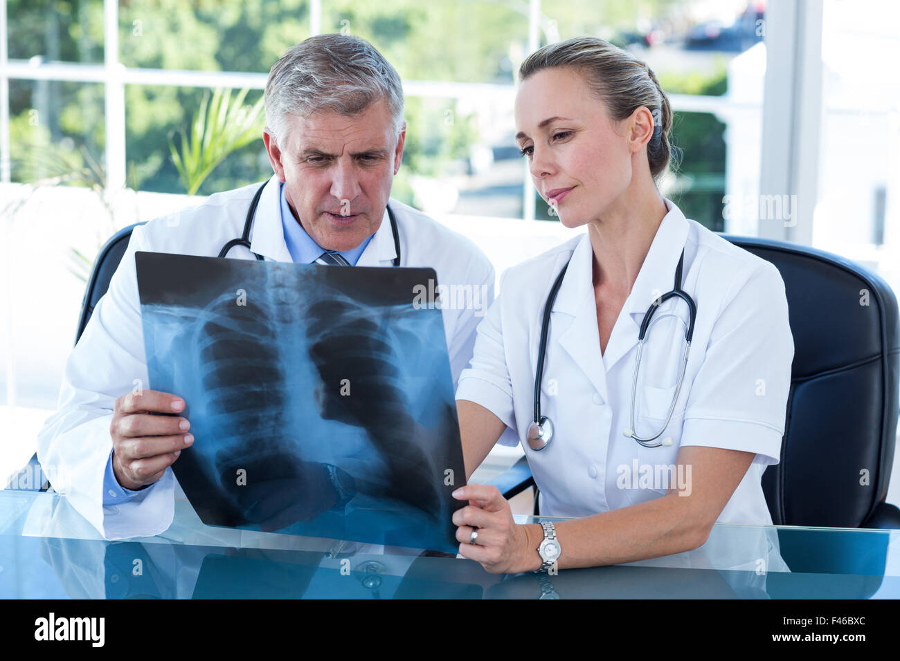 Medical team working together checking hi-res stock photography and ...