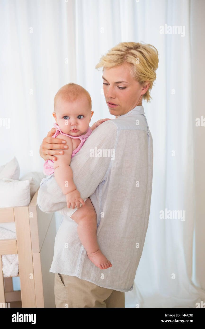Happy mother holding baby girl Stock Photo - Alamy