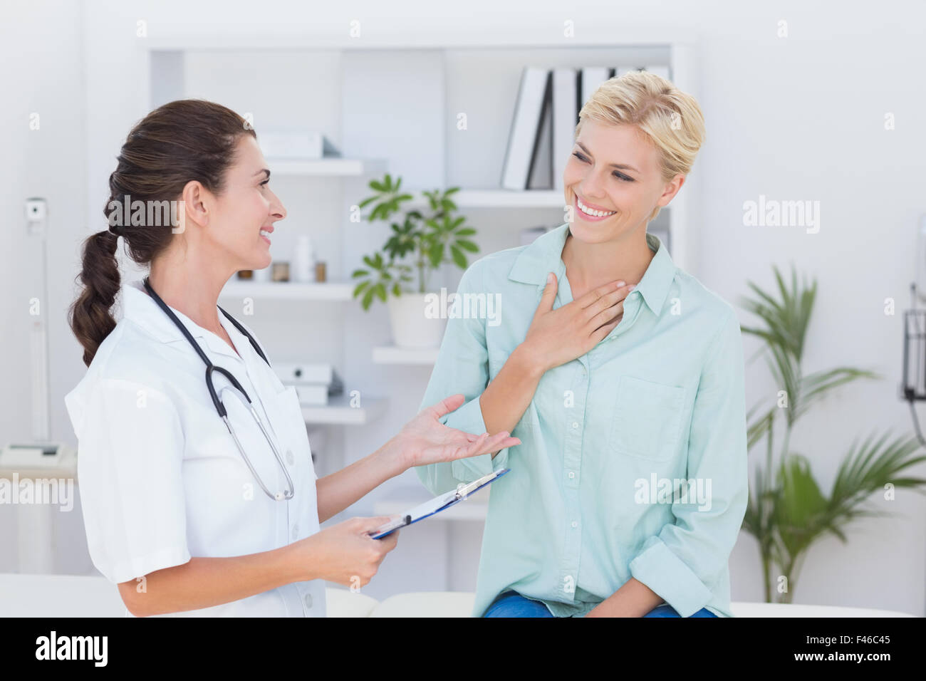 patient smiling to her doctor Stock Photo - Alamy