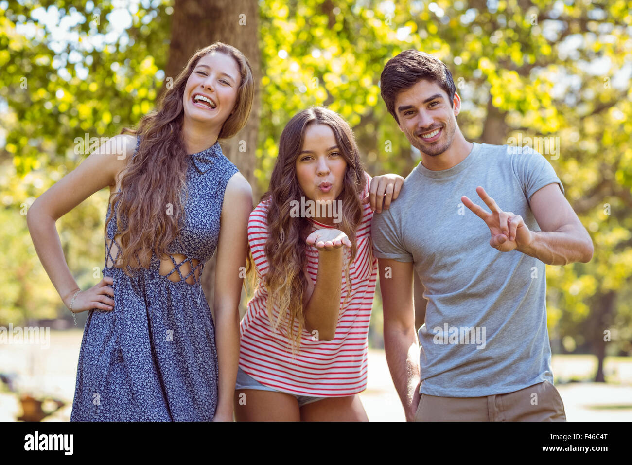 Happy friends smiling at camera Stock Photo - Alamy