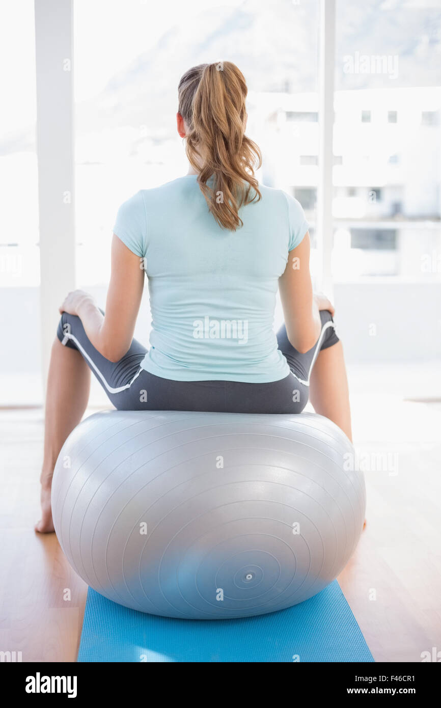 Woman sitting on exercise ball Stock Photo - Alamy