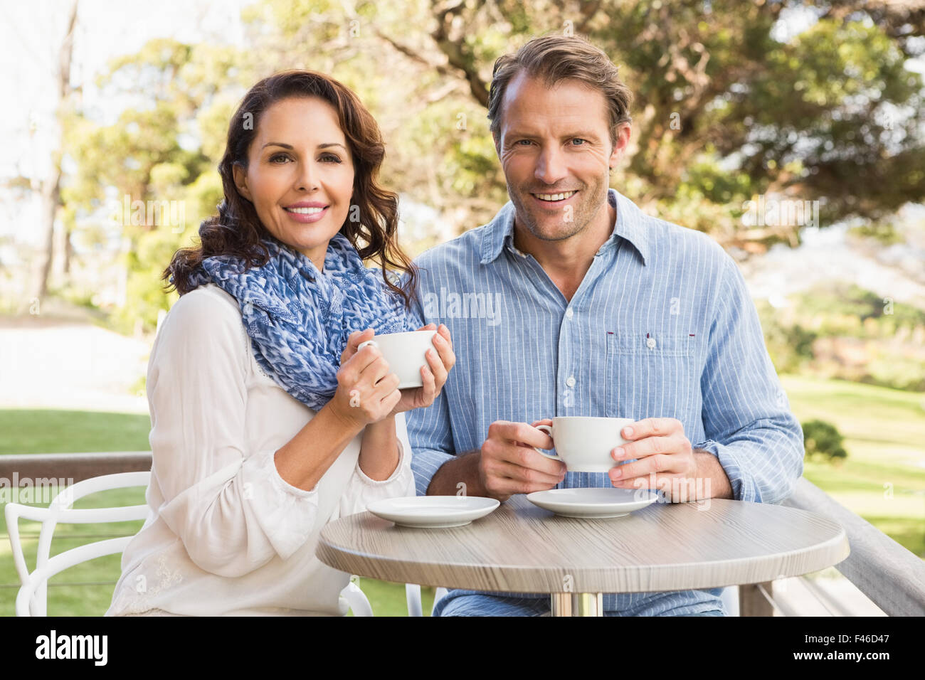 Cute couple having coffee together Stock Photo - Alamy