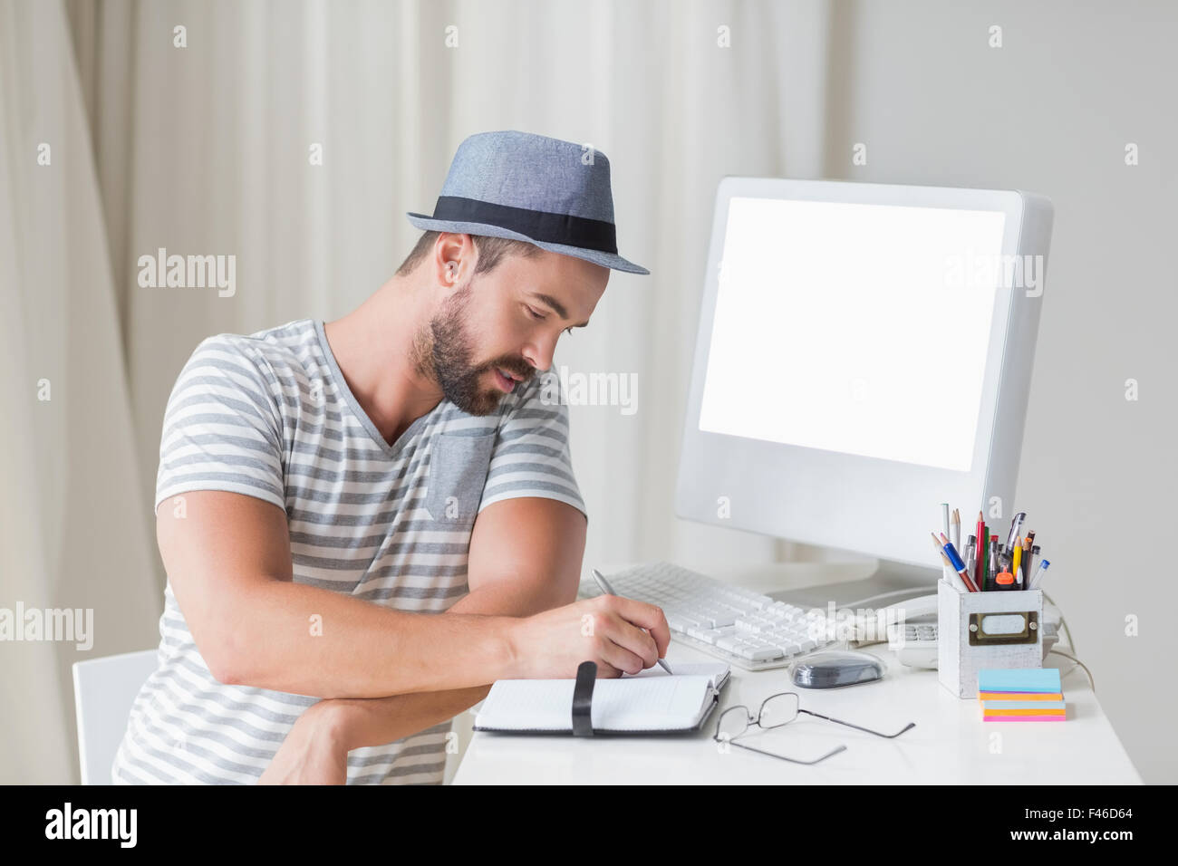 Handsome cheerful young man writing hi-res stock photography and images ...
