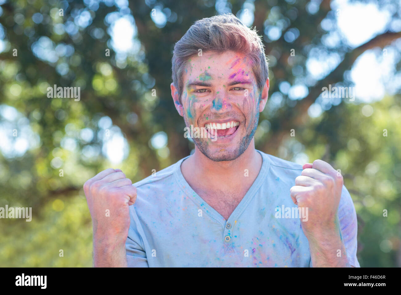 Happy man covered in powder paint Stock Photo - Alamy